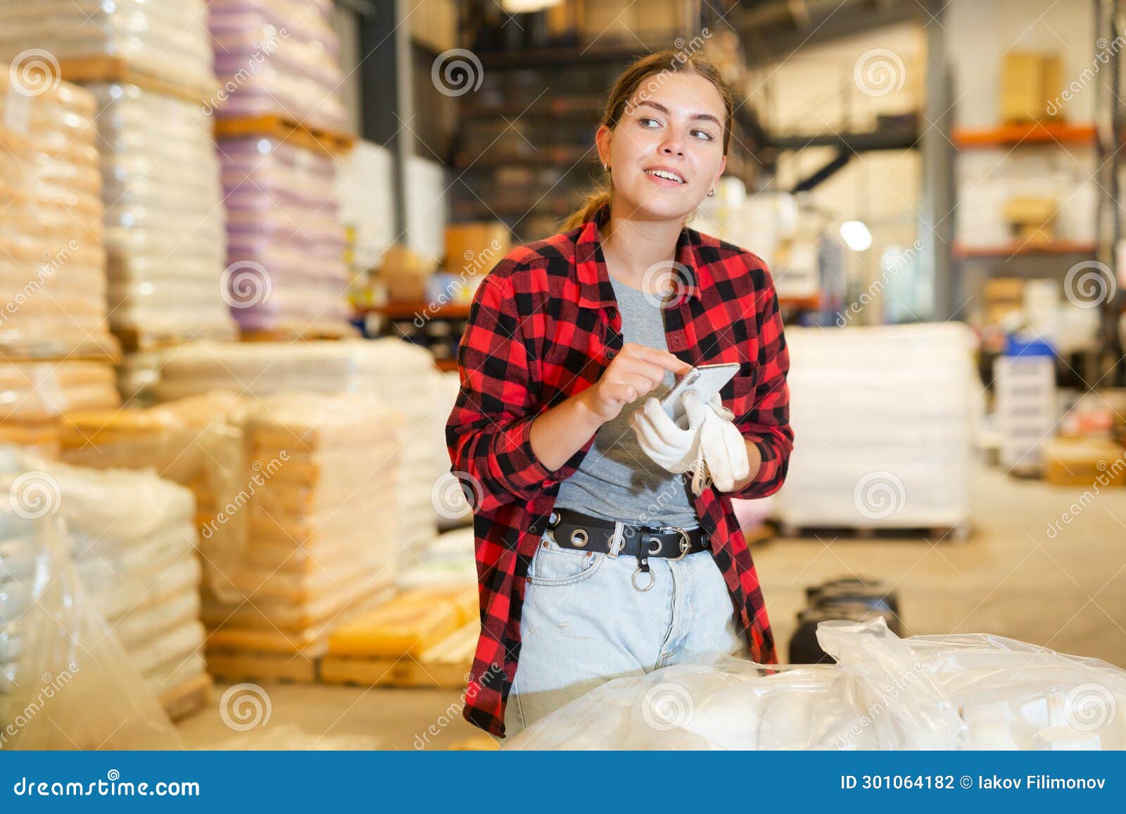 Young Woman Warehouse Worker Using Smartphone in Her Work Stock Photo ...