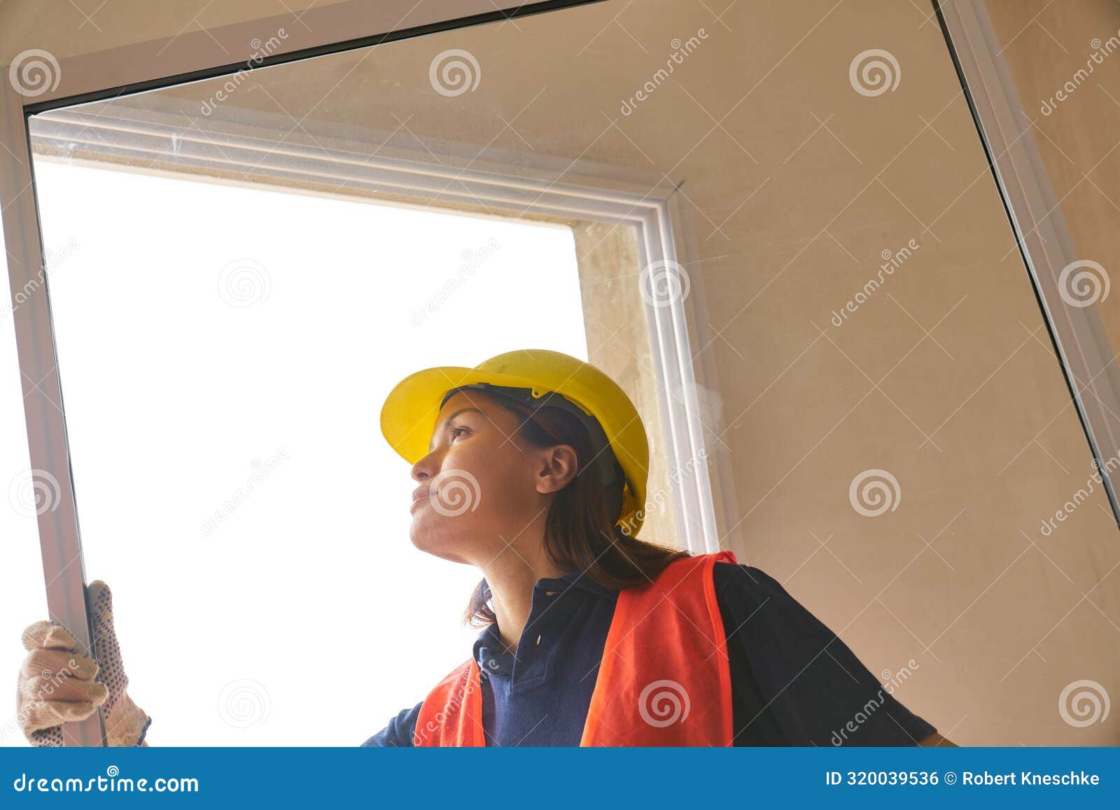 Young Female Construction Worker Wearing Safety Hardhat Installing ...