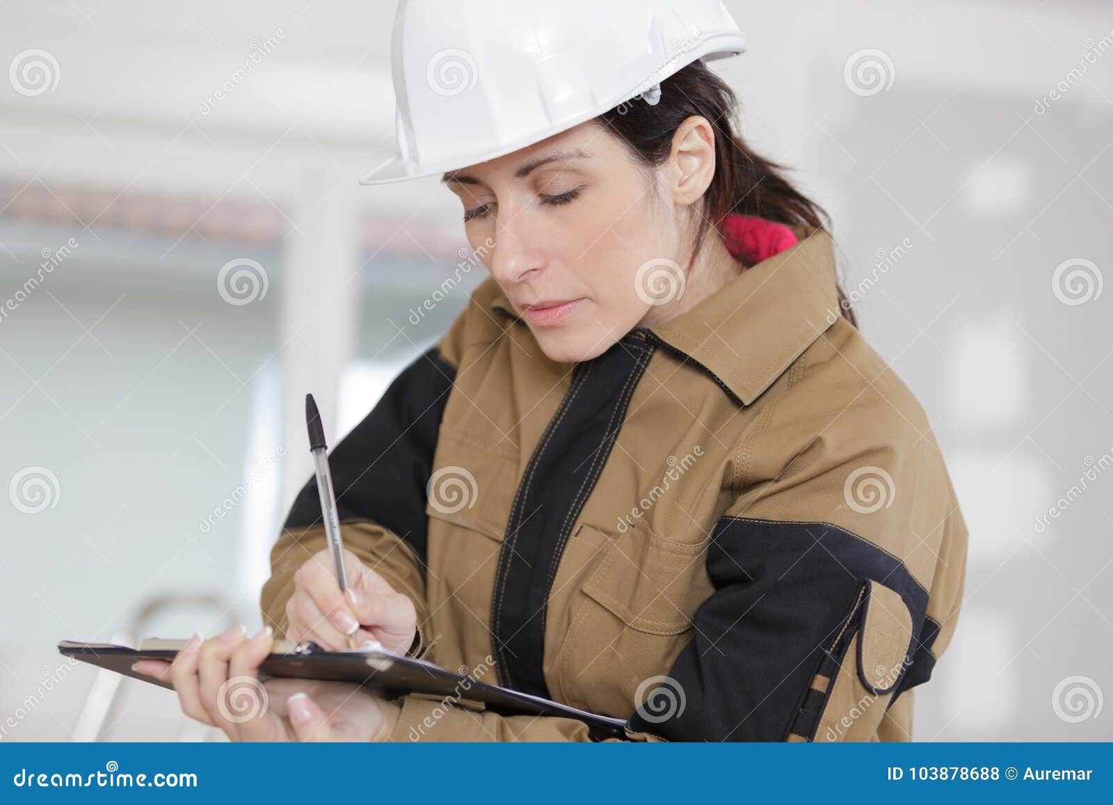 Female Construction Worker Taking Notes at Construction Site Stock ...