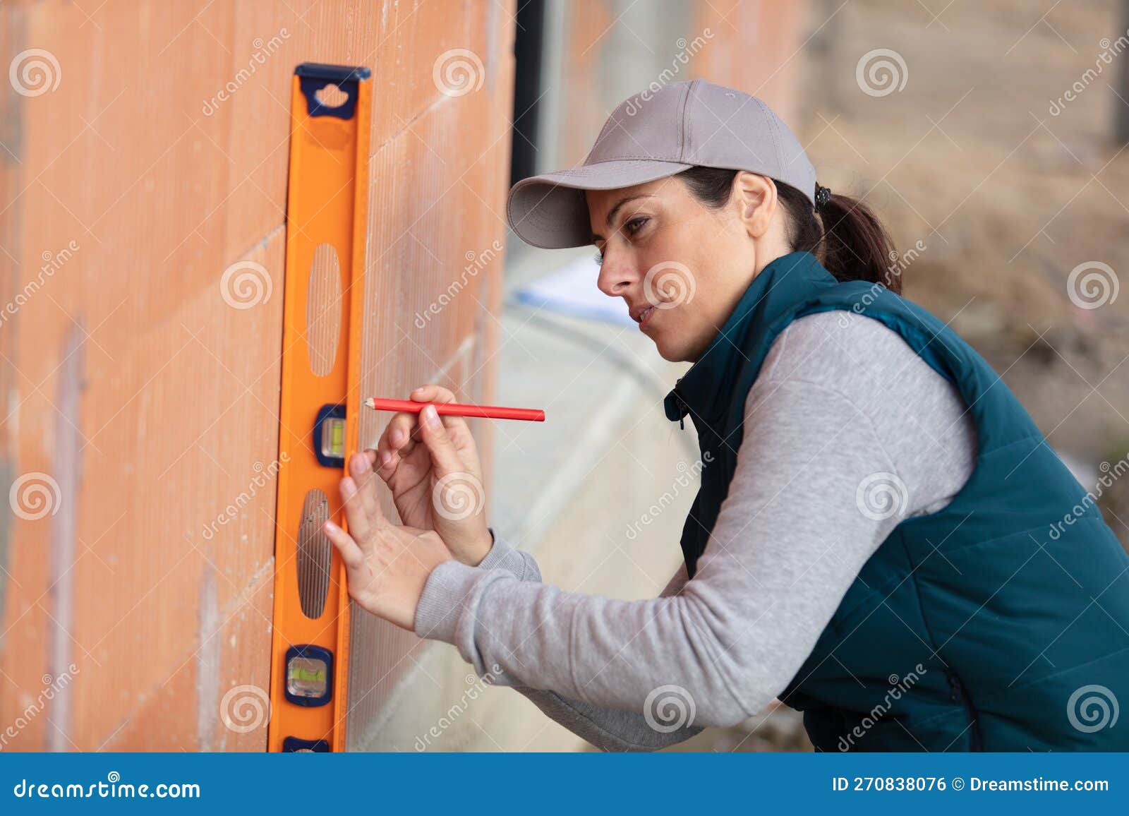 Female Construction Worker Using Vertical Spirit Level Stock Photo ...