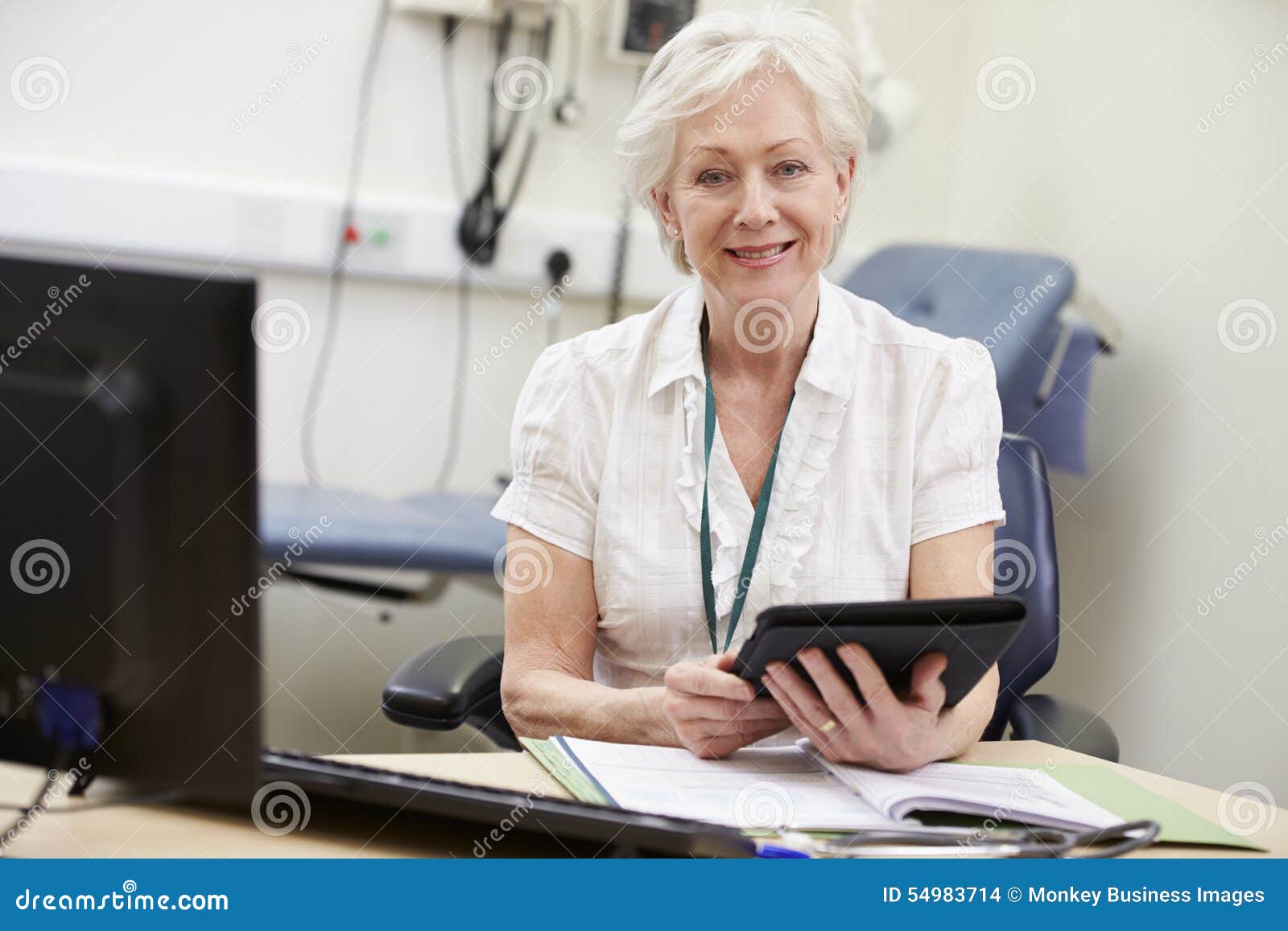 Female Consultant Working at Desk Using Digital Tablet Stock Photo ...