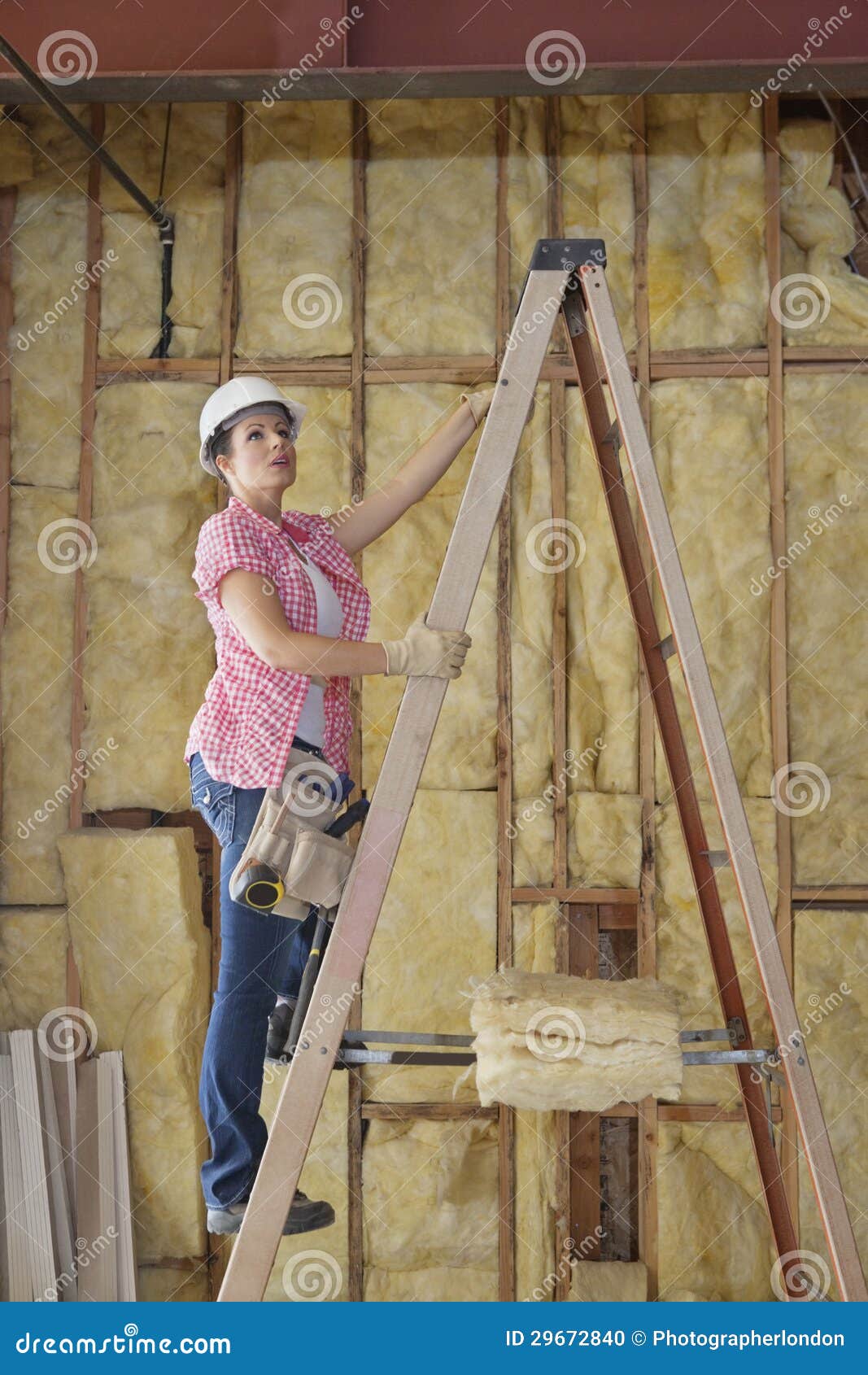 Female Contractor Climbing Up the Ladder at Construction Site Stock ...