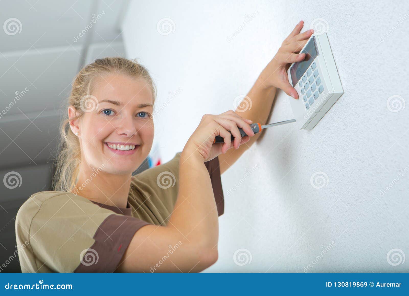 Female Contractor Fitting Electronic Keypad To Wall Stock Image - Image ...
