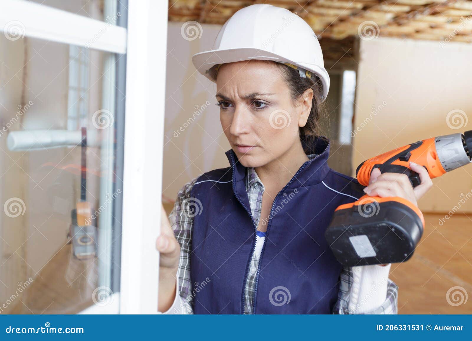 Female Contractor Using Cordless Drill To Install Windows Stock Image ...