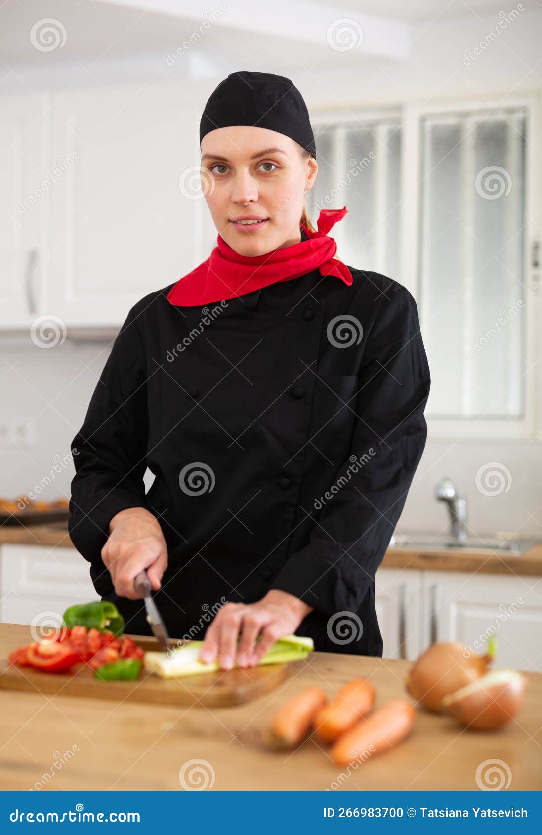 Female Cook in Black Uniform Chopping Vegetables in Kitchen Stock Photo ...