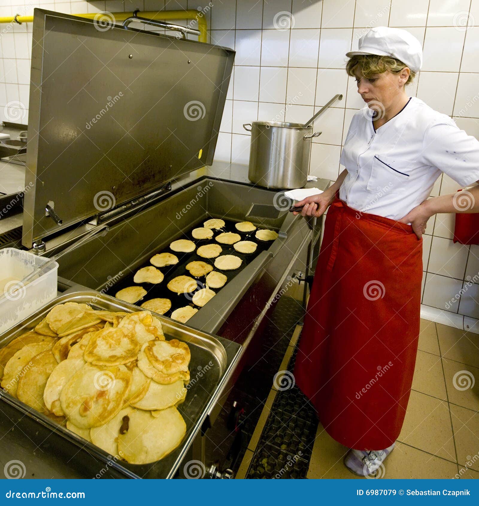 Female Cook Arranging And Decorating Burger Plate With French Fries On ...