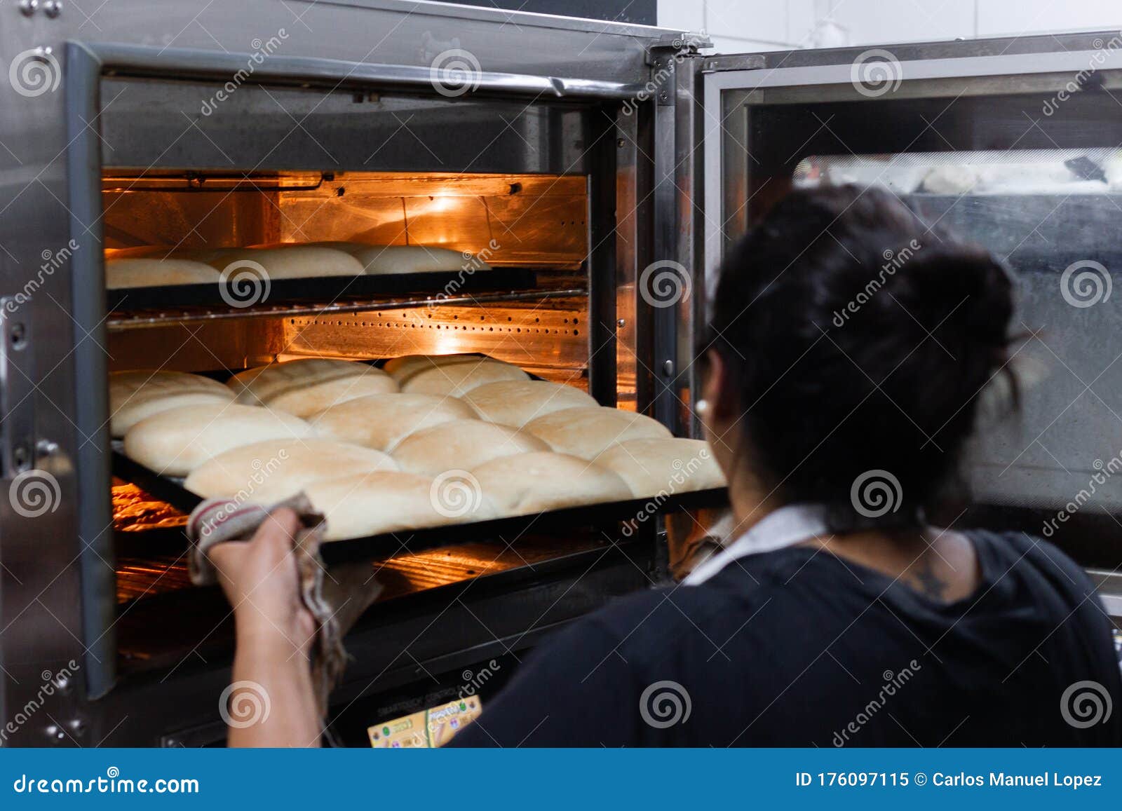 Female Cook Removing Bread from Industrial Oven Stock Image - Image of ...