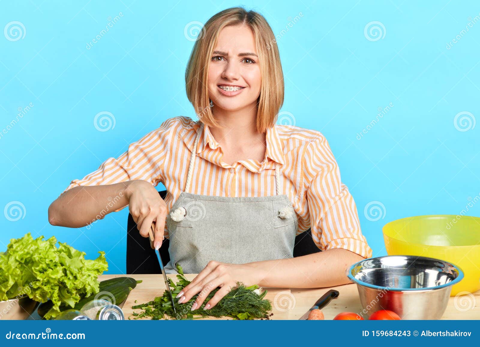 Female Cook Wearing Apron and Holding Knife while Making Delicious ... Female Cook Wearing Apron and Holding Knife while Making Delicious ...