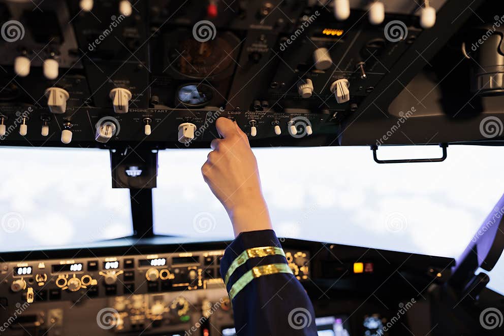 Female Copilot Pushing Buttons and Switch on Dashboard Panel Stock ...