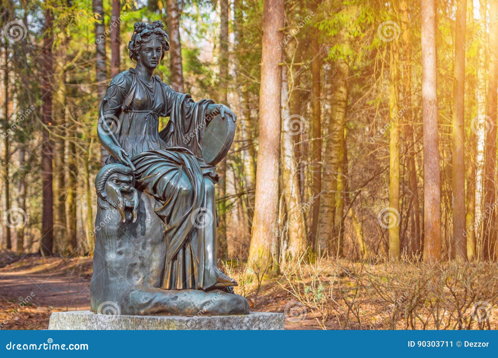 A Female Copper Statue of a Deity with a Harp in the Woods Stock Image ...