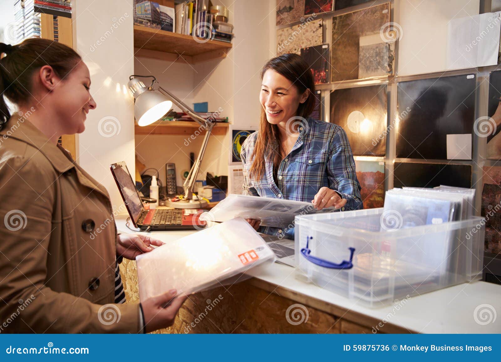 Female Customer Being Served at the Counter of a Record Shop Stock ...