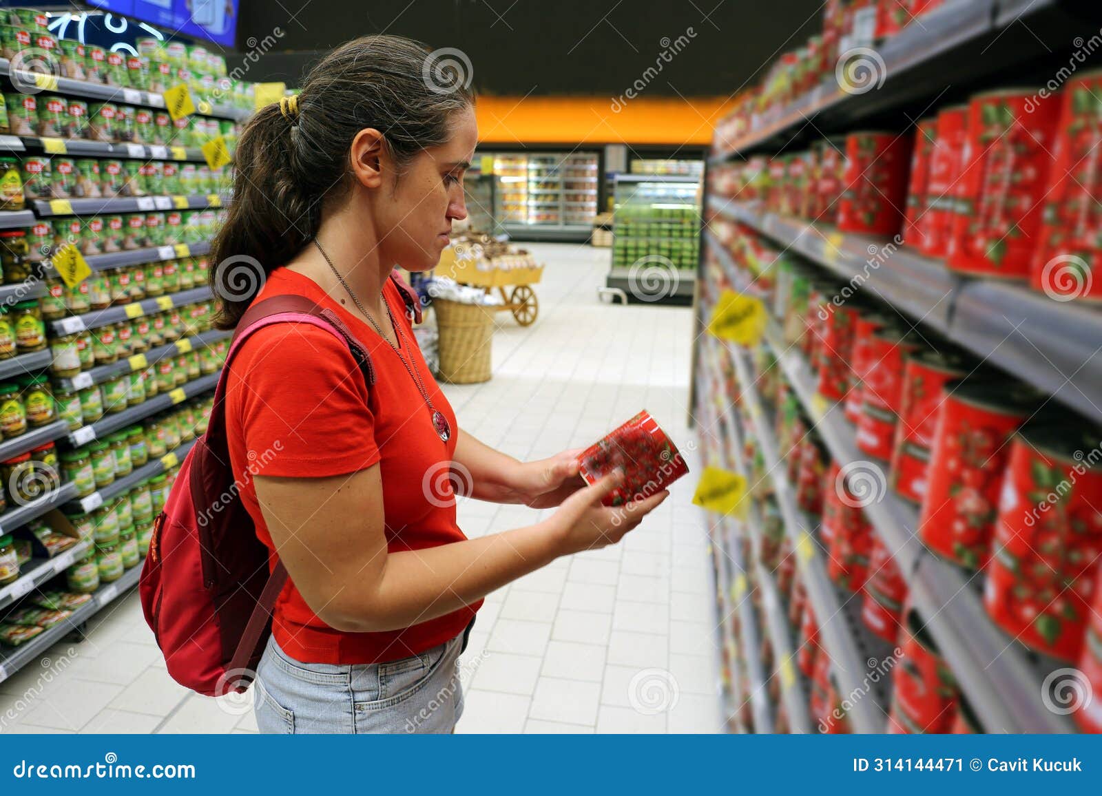 A Female Customer is Interested in Content of Tomato Paste in Grocery ...