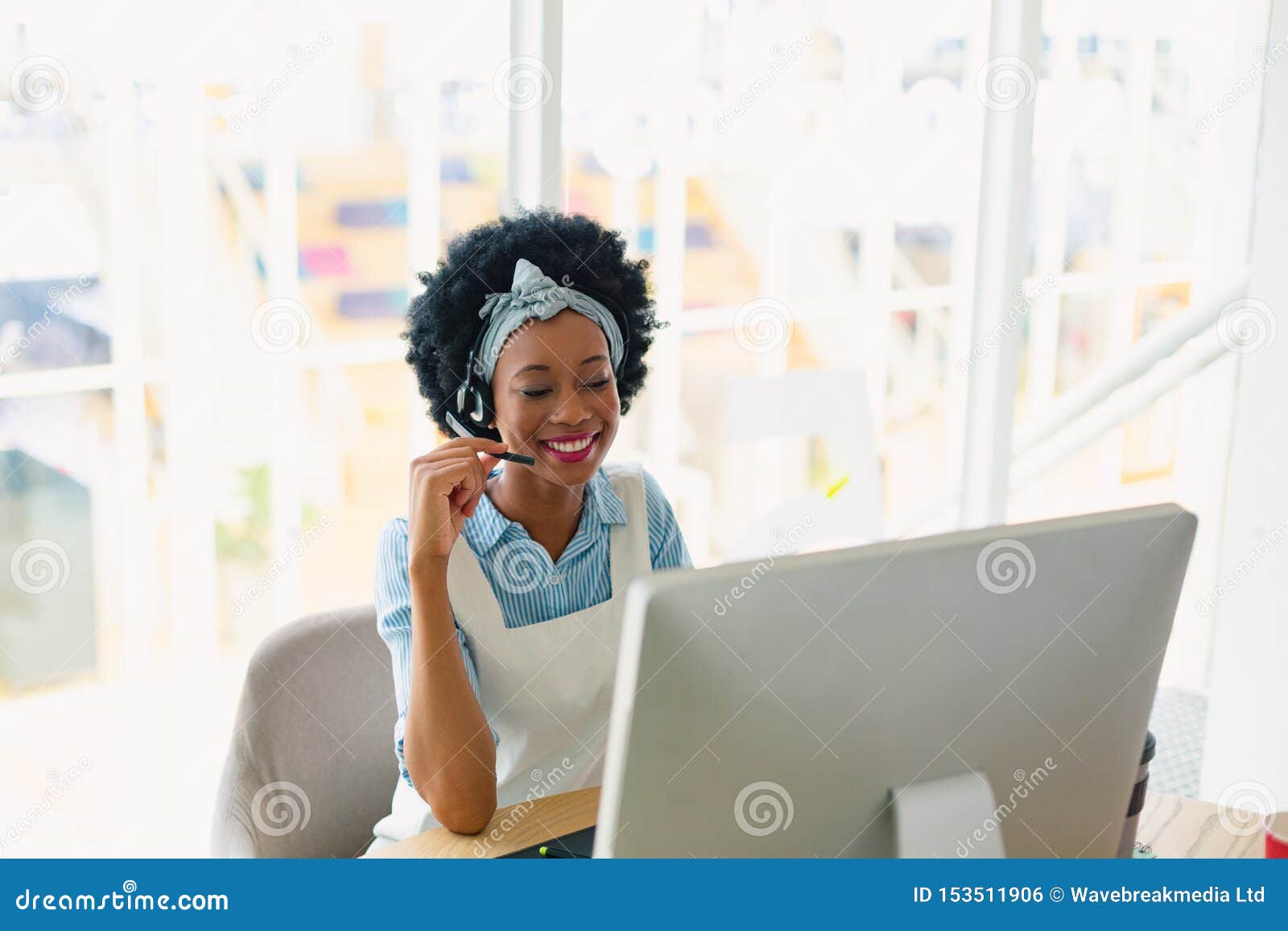 Female Customer Service Executive Talking on Headset at Desk in Office ... Female Customer Service Executive Talking on Headset at Desk in Office ...