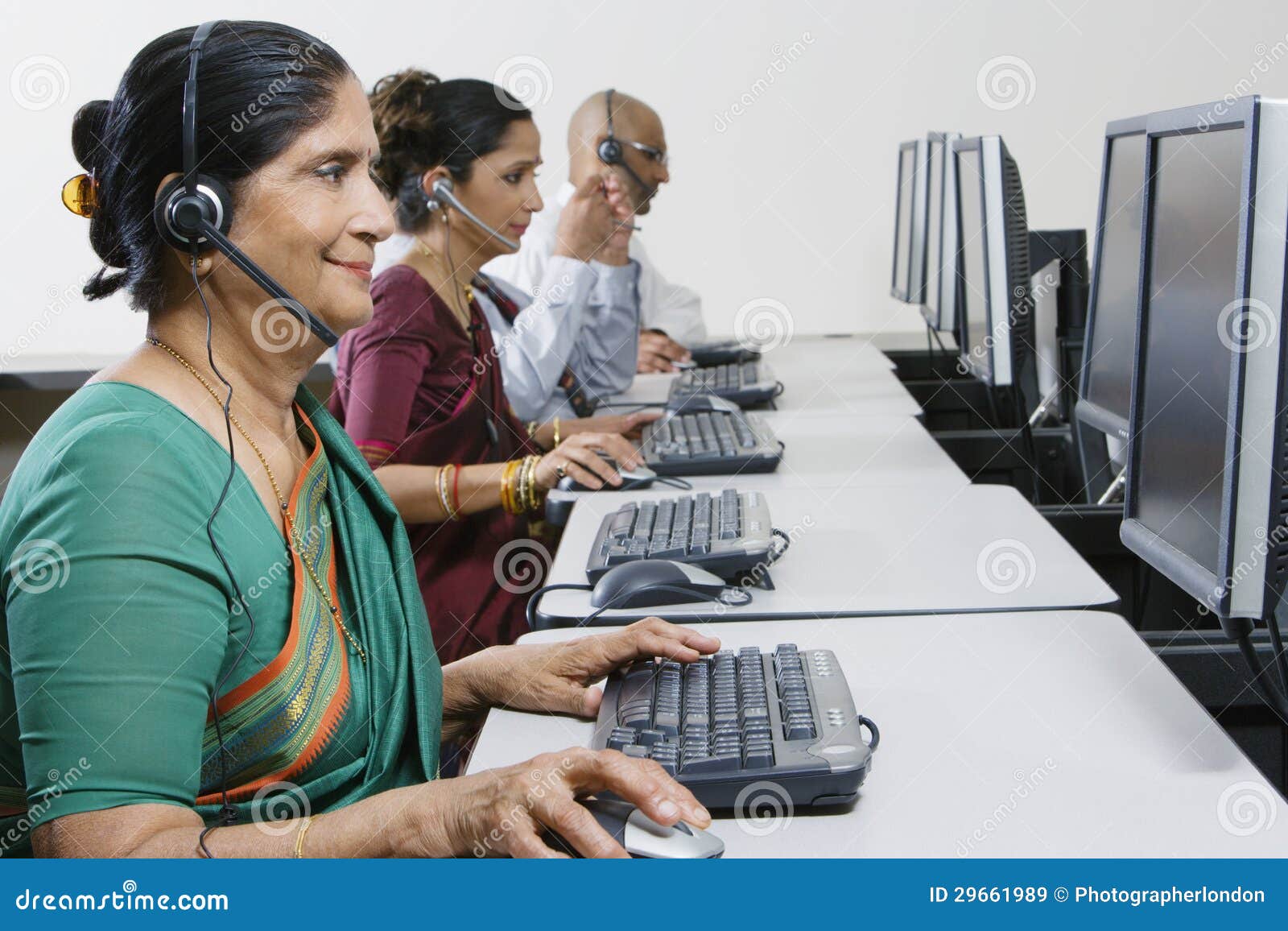 Female Customer Service Operator Working with Colleagues at Office ...