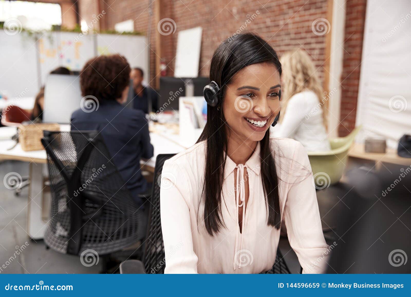 Female Customer Services Agent Working at Desk in Call Center Stock ...