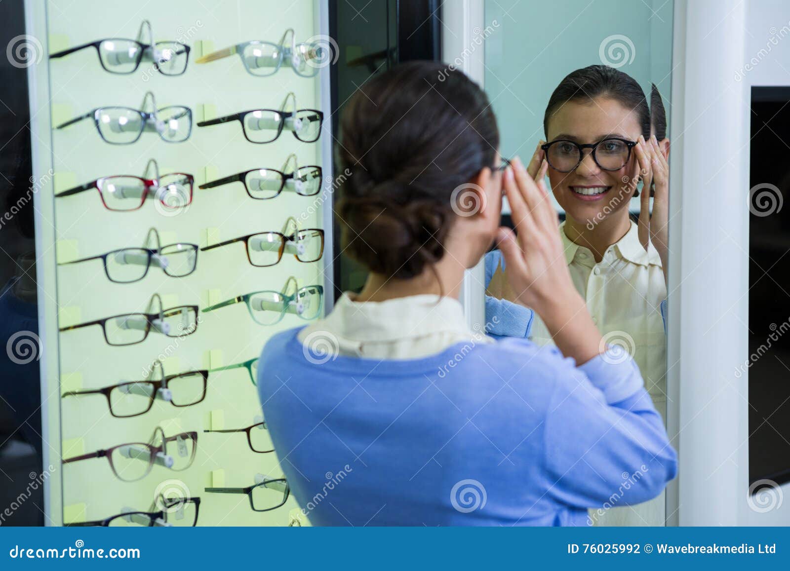Female Customer Wearing Spectacles and Checking in Mirror Stock Photo ...