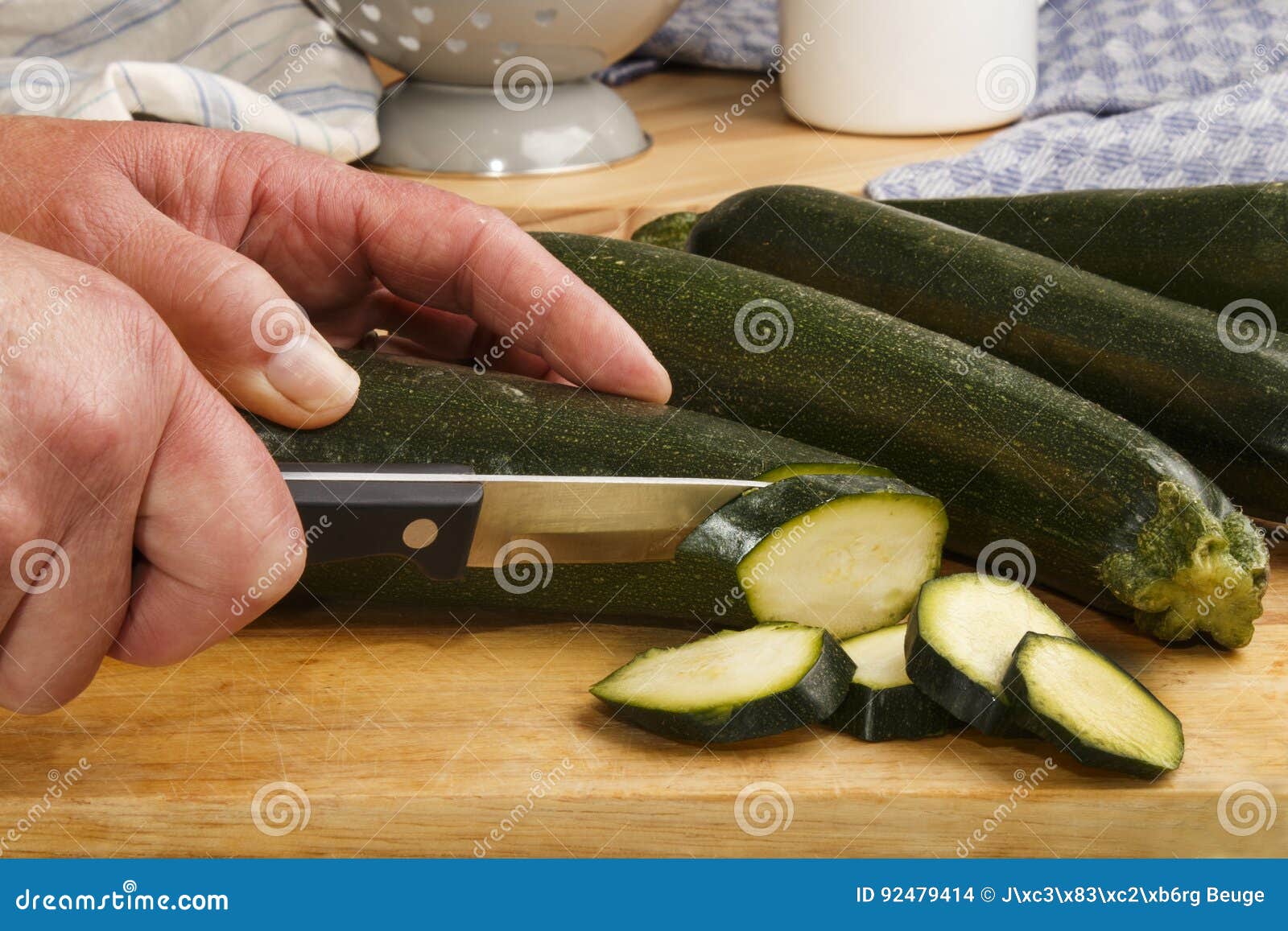 Female Cuts Courgette on Wooden Board in Slices Stock Photo - Image of ...