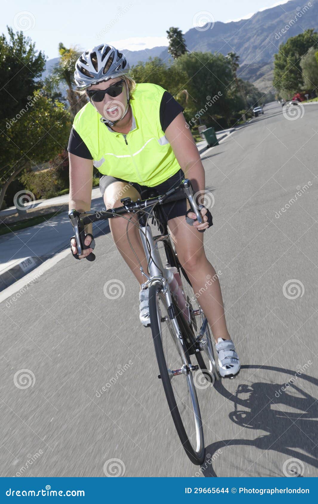 Female Cyclist Riding Bicycle on Street Stock Photo - Image of adult ...