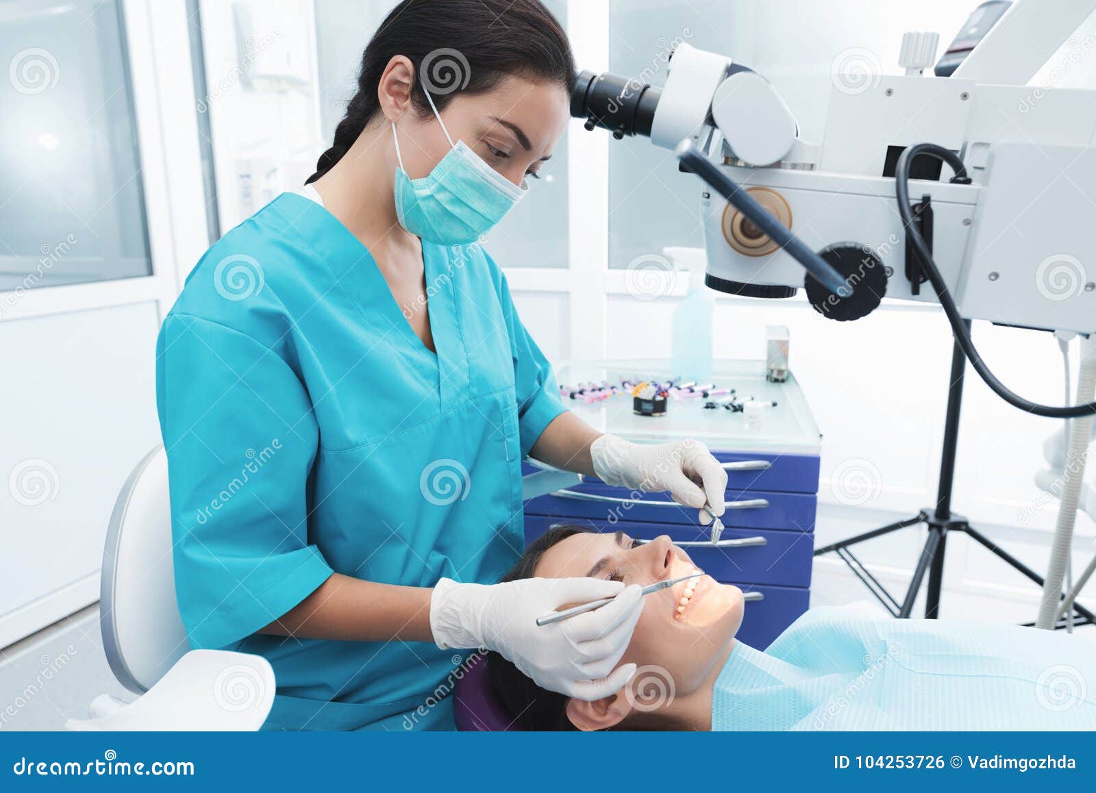 A Female Dentist Is Treating A Patient She Is Sitting On The Dental