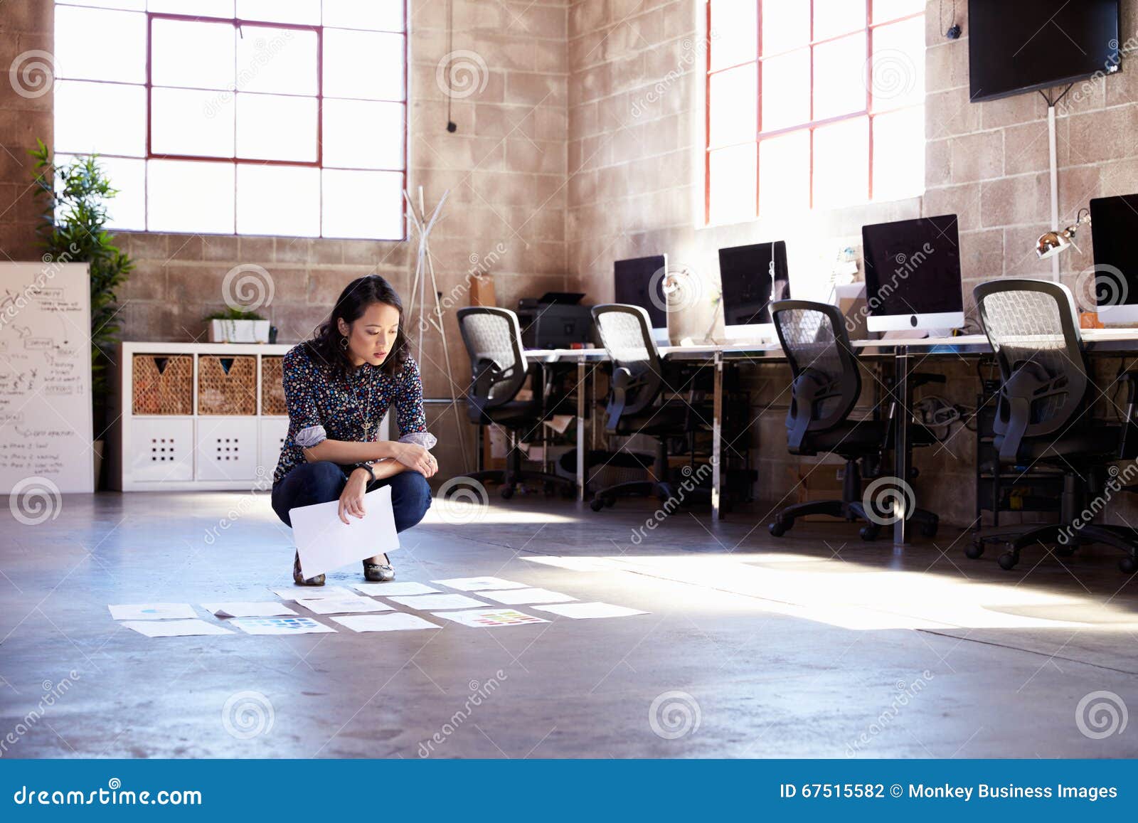 Female Designer Planning Layout on Floor of Modern Office Stock Photo ...