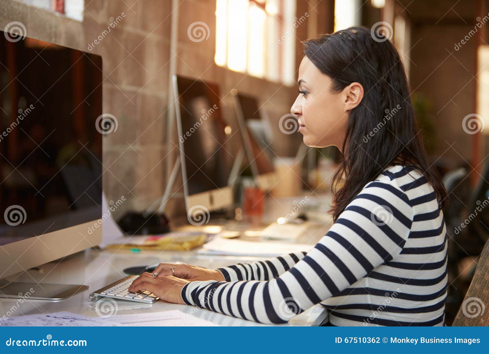 Female Designer Using Computer at Desk in Modern Office Stock Photo ...