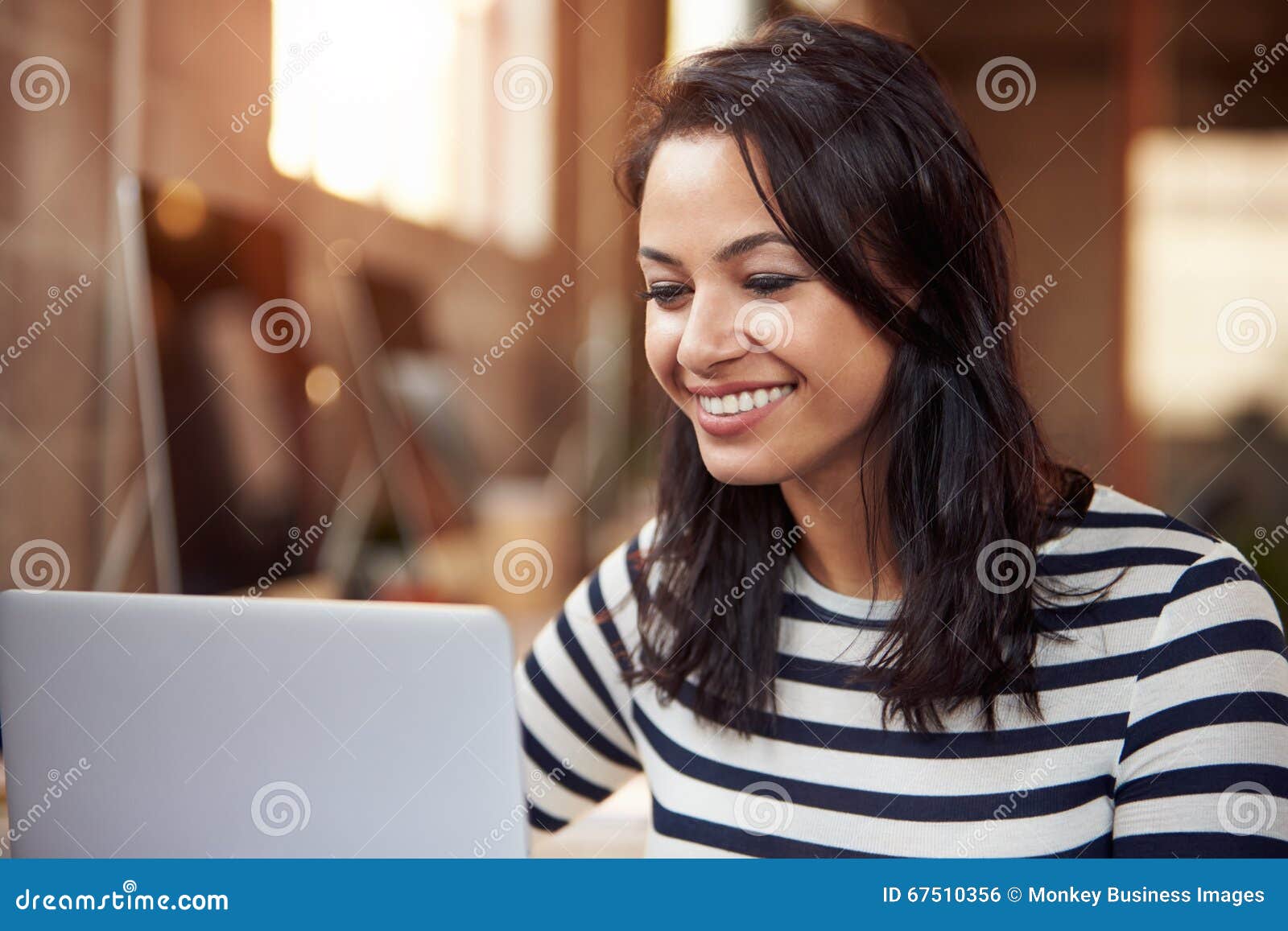 Female Designer Using Laptop at Desk in Modern Office Stock Photo ...