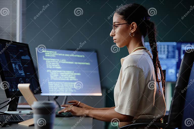 Female it Developer Working on Multiple Computers Writing Code at Desk ...