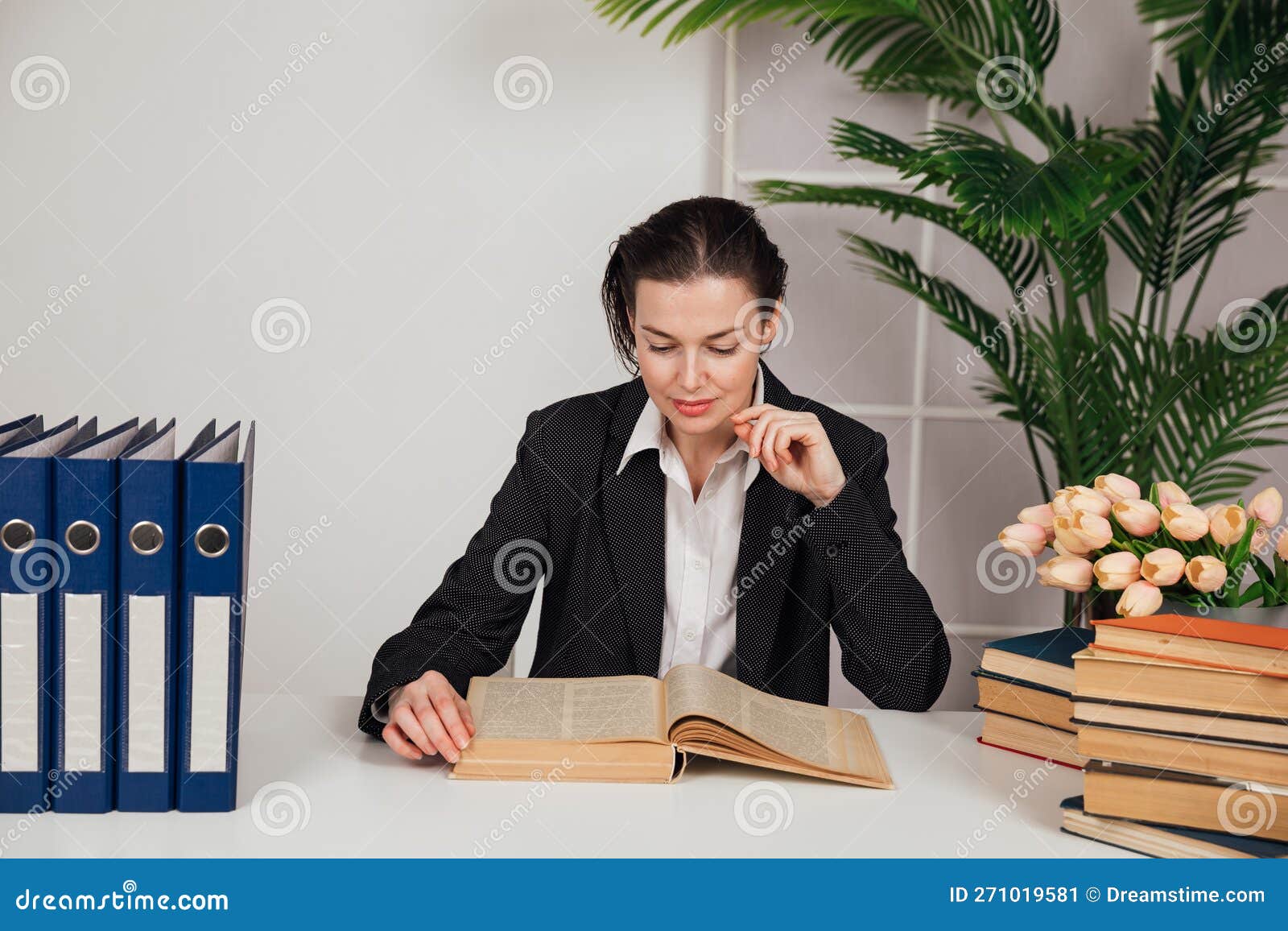 The Female Director in the Office Reads a Book in the Office Stock ...