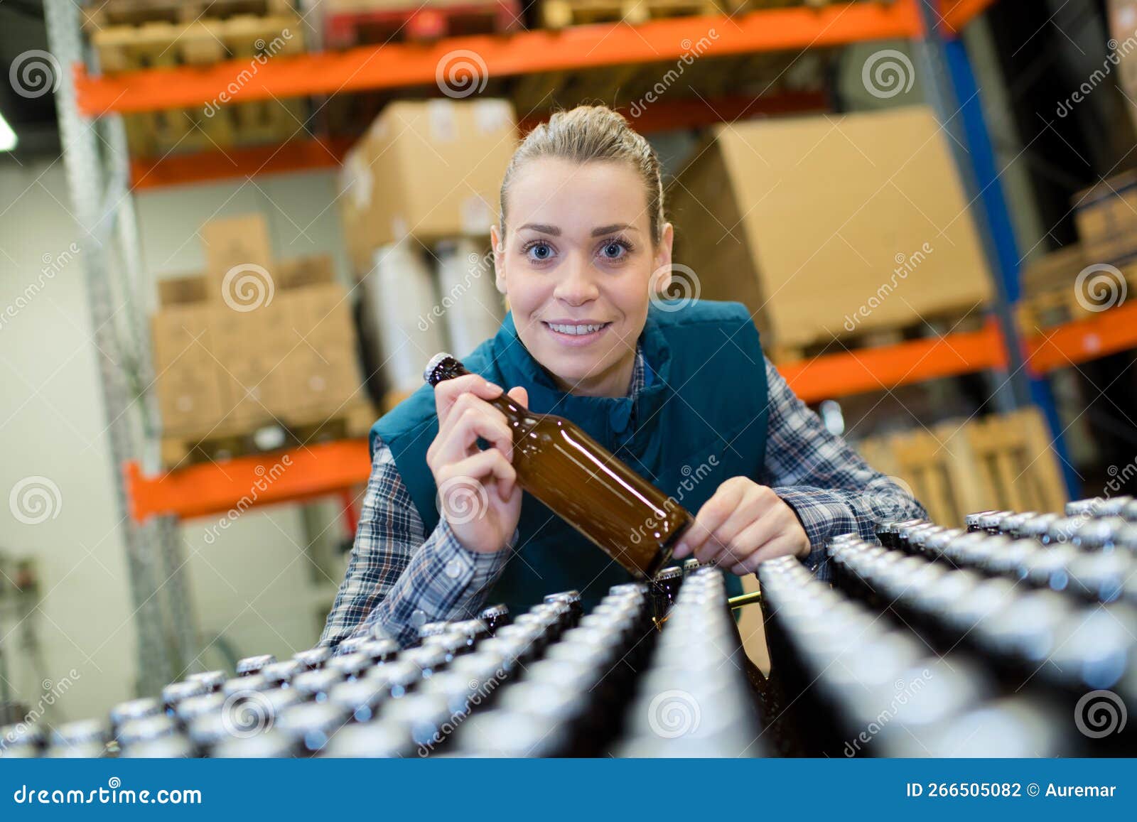 Female Distillery Worker Holding Bottled Beer Stock Photo - Image of ...
