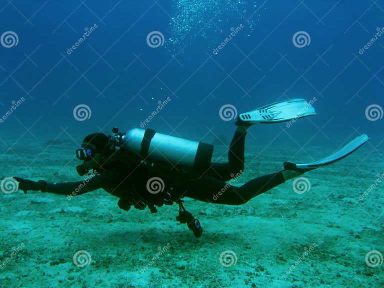 Female Dive Master Pointing Underwater Stock Image - Image of dark ...