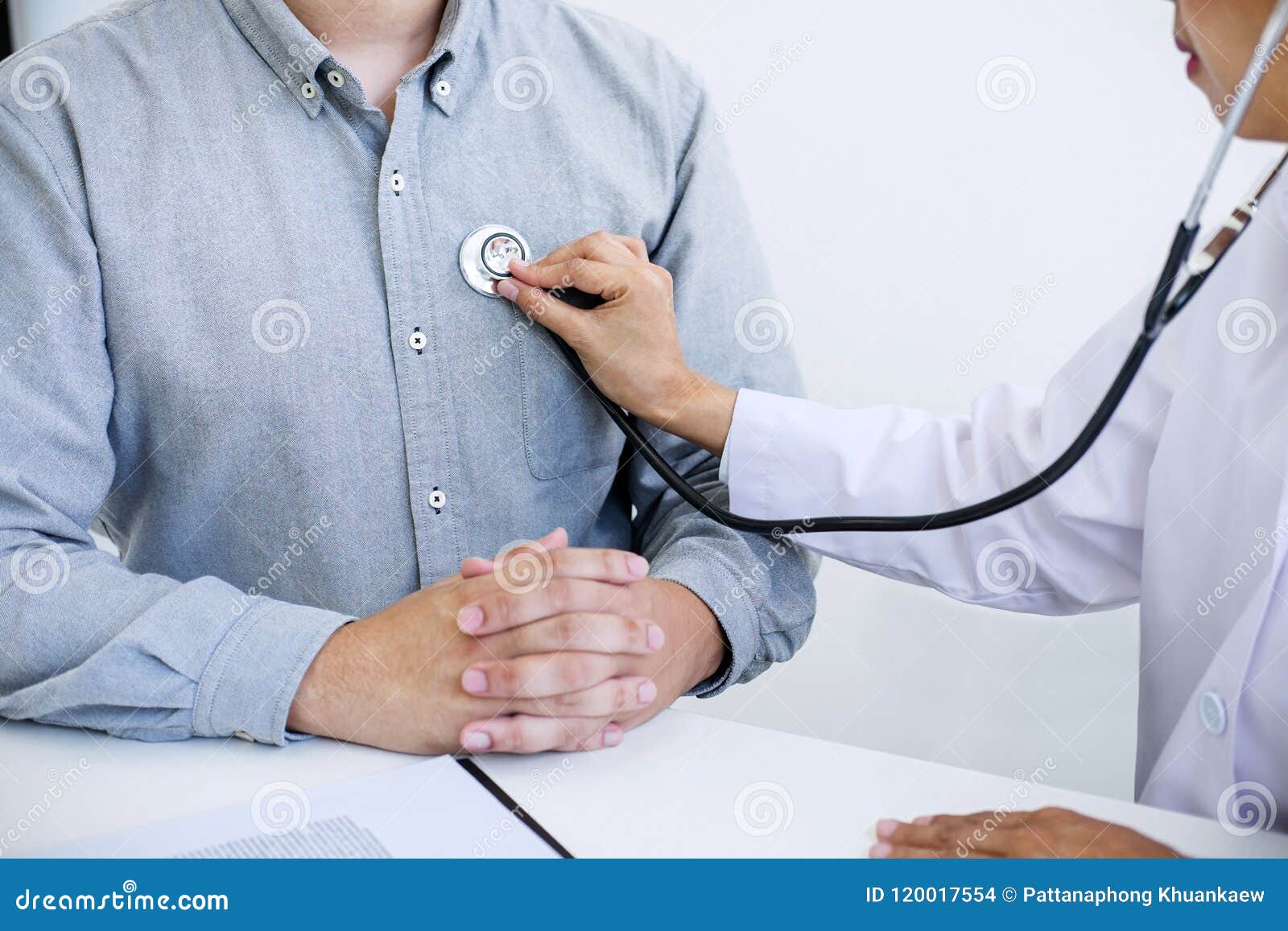 Female Doctor Checking Heart Beat Of Patient And Recommend Treat Stock
