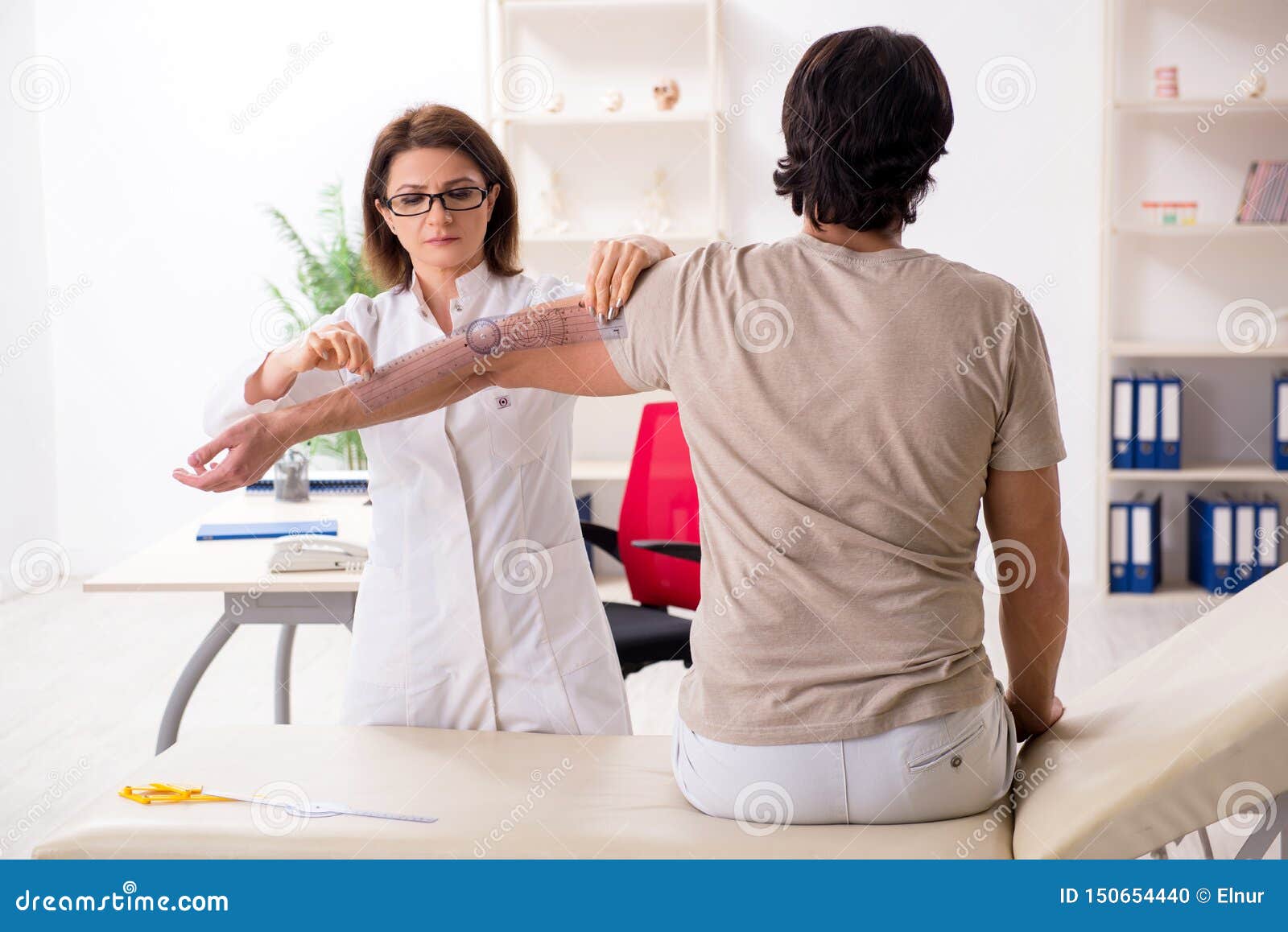 The Female Doctor Checking Patient`s Joint Flexibility with Goniometer ...