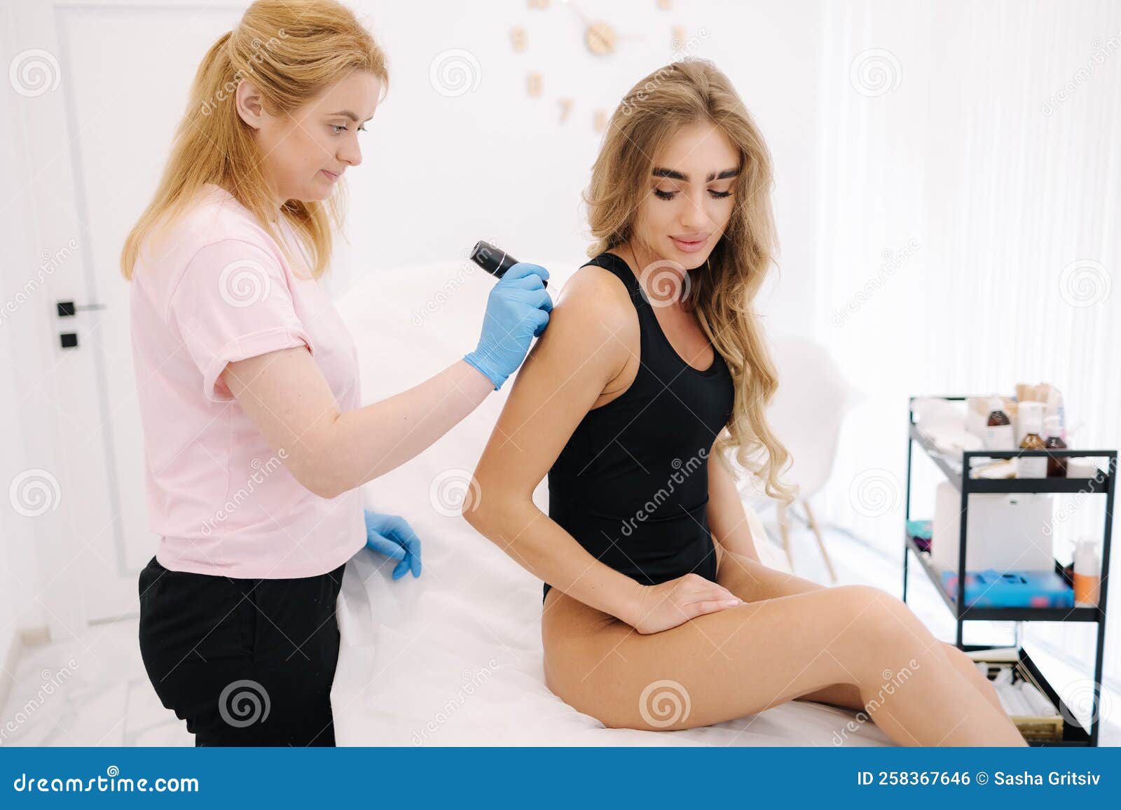 Female Doctor Dermatologist Examines Birthmarks And Skin Moles Of The