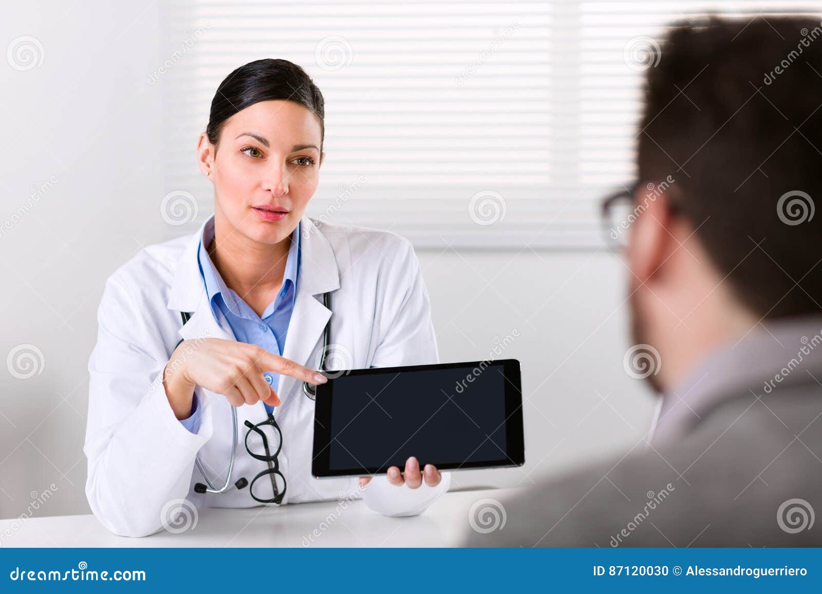 Female Doctor Explaining Something To a Patient Stock Photo - Image of ...