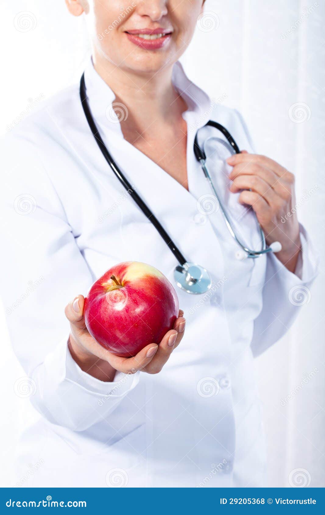 Female Doctor Giving Red Apple Stock Photo - Image of patient, practice ...