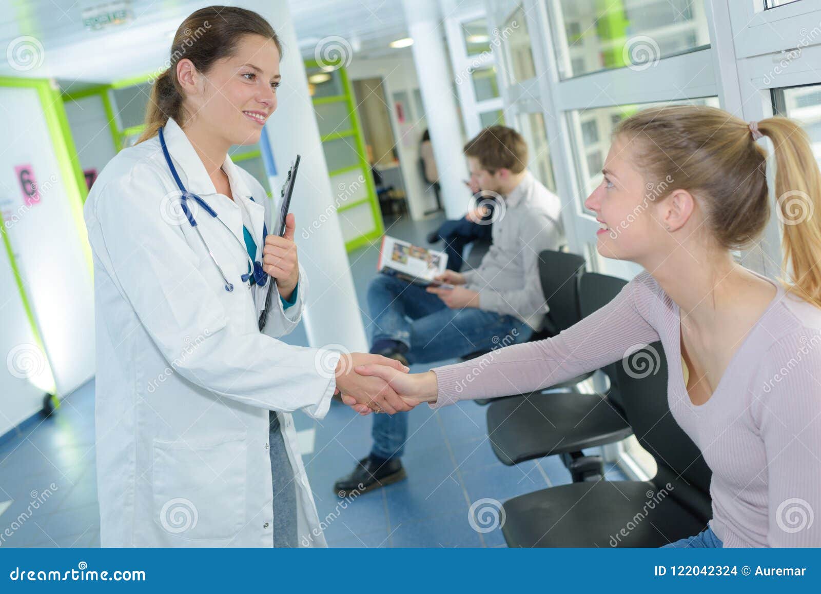 Female Doctor Greeting Female Patient Stock Photo - Image of people ...