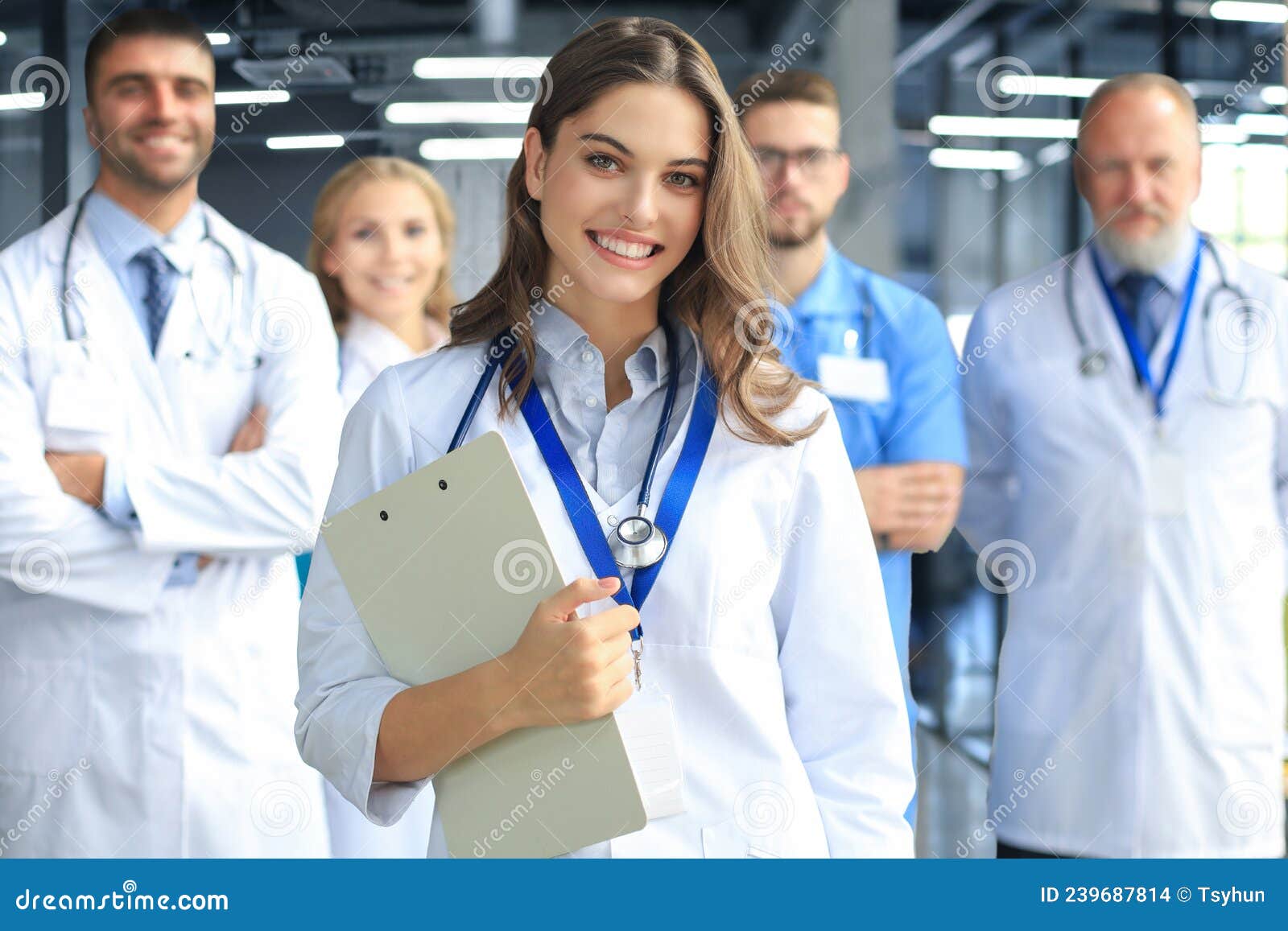 Female Doctor with Group of Happy Successful Colleagues. Stock Photo ...