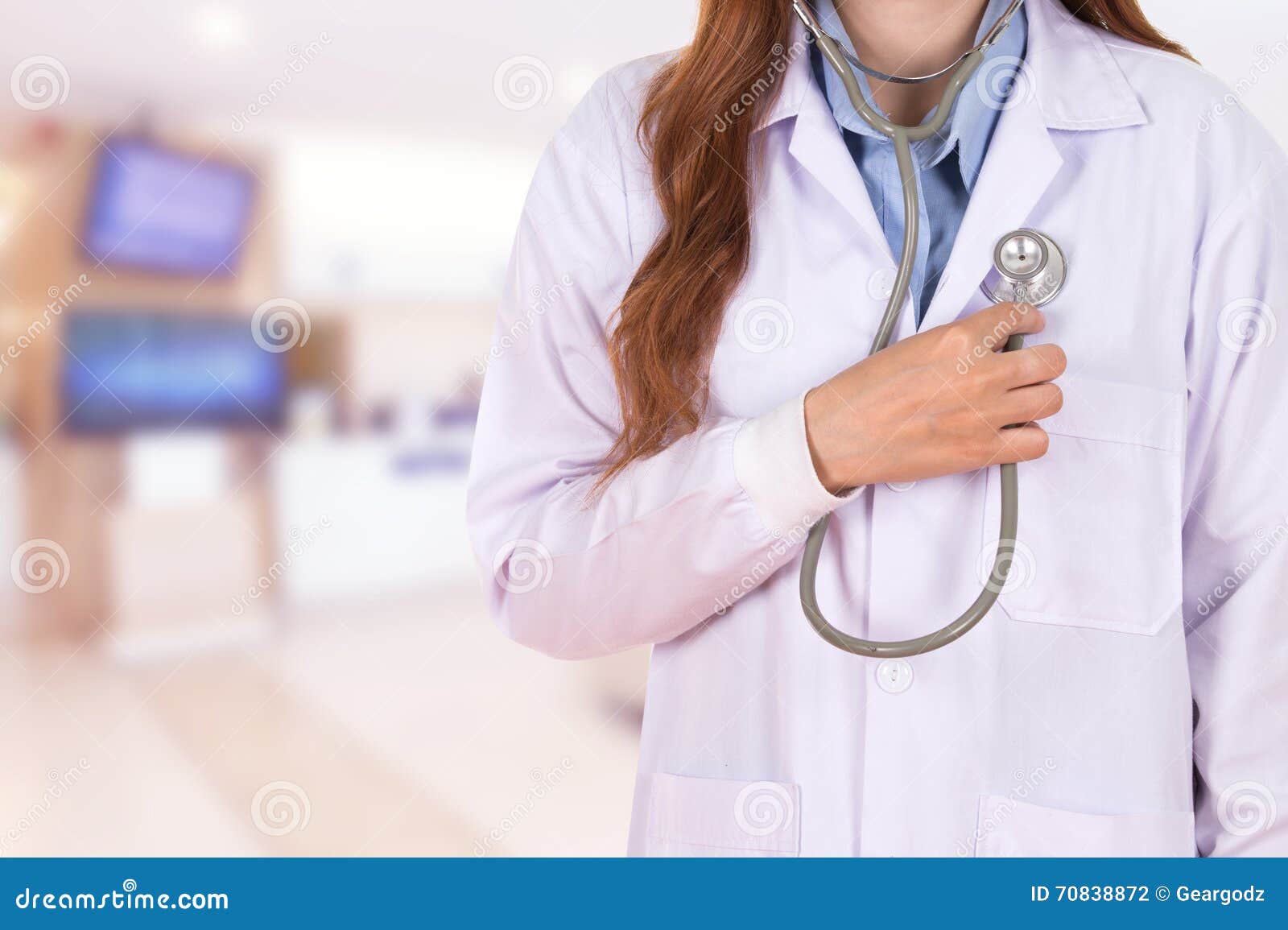 Female Doctor Listening His Heart With Stethoscope In Hospital Stock