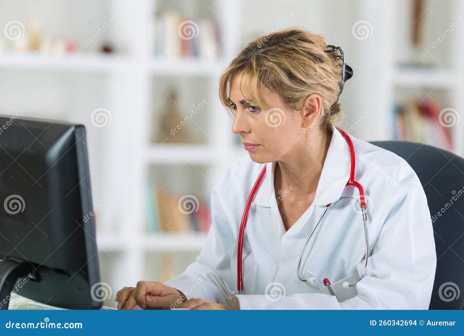 Female Doctor Looking at Computer in Hospital Stock Photo - Image of ...