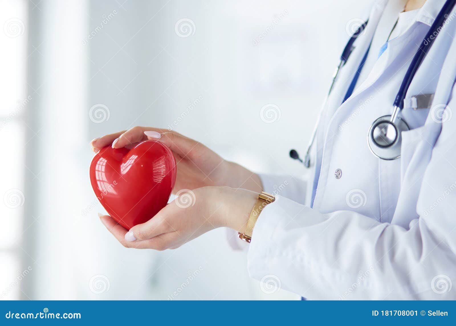 Female Doctor With Stethoscope Holding Heart On Light Background Stock