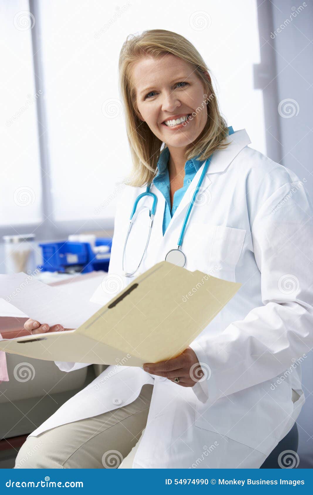 Female Doctor in Surgery Reading Patient Notes Stock Photo - Image of ...