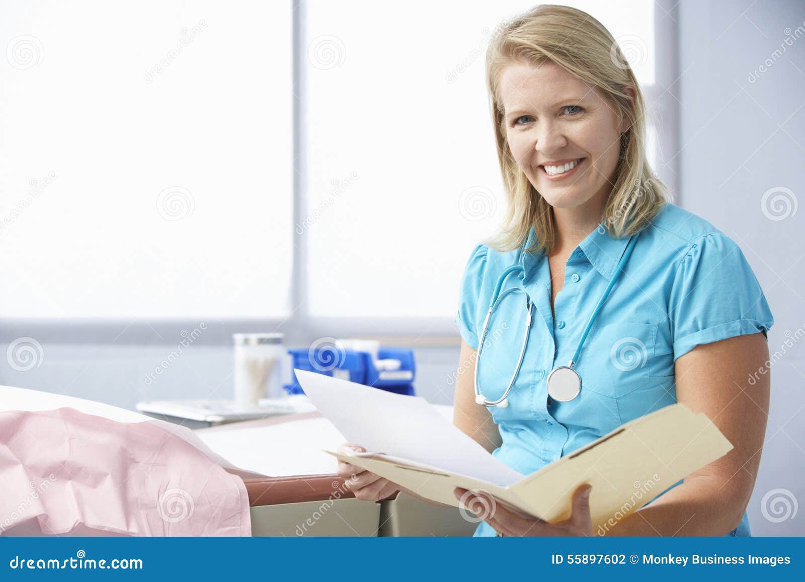 Female Doctor in Surgery Reading Patient Notes Stock Photo - Image of ...