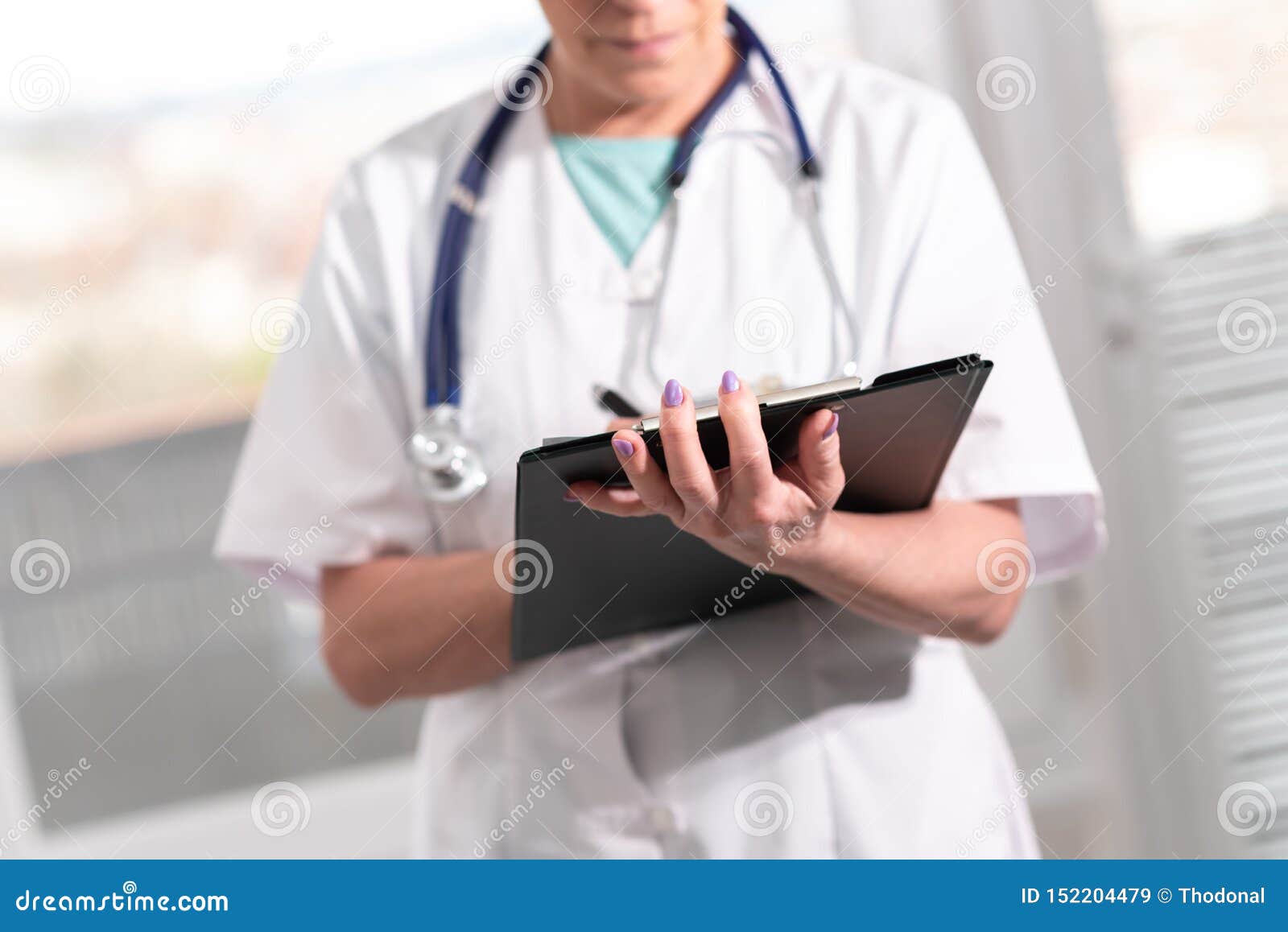 Female Doctor Taking Notes on Clipboard Stock Image - Image of ...