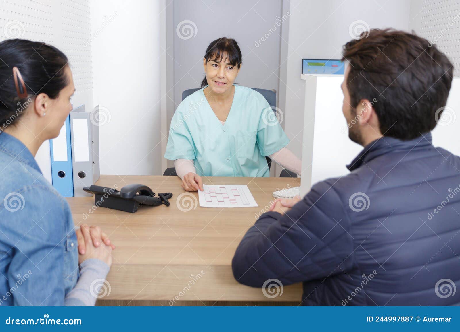 Female Doctor Talking with Couple during Appointment Stock Image ...