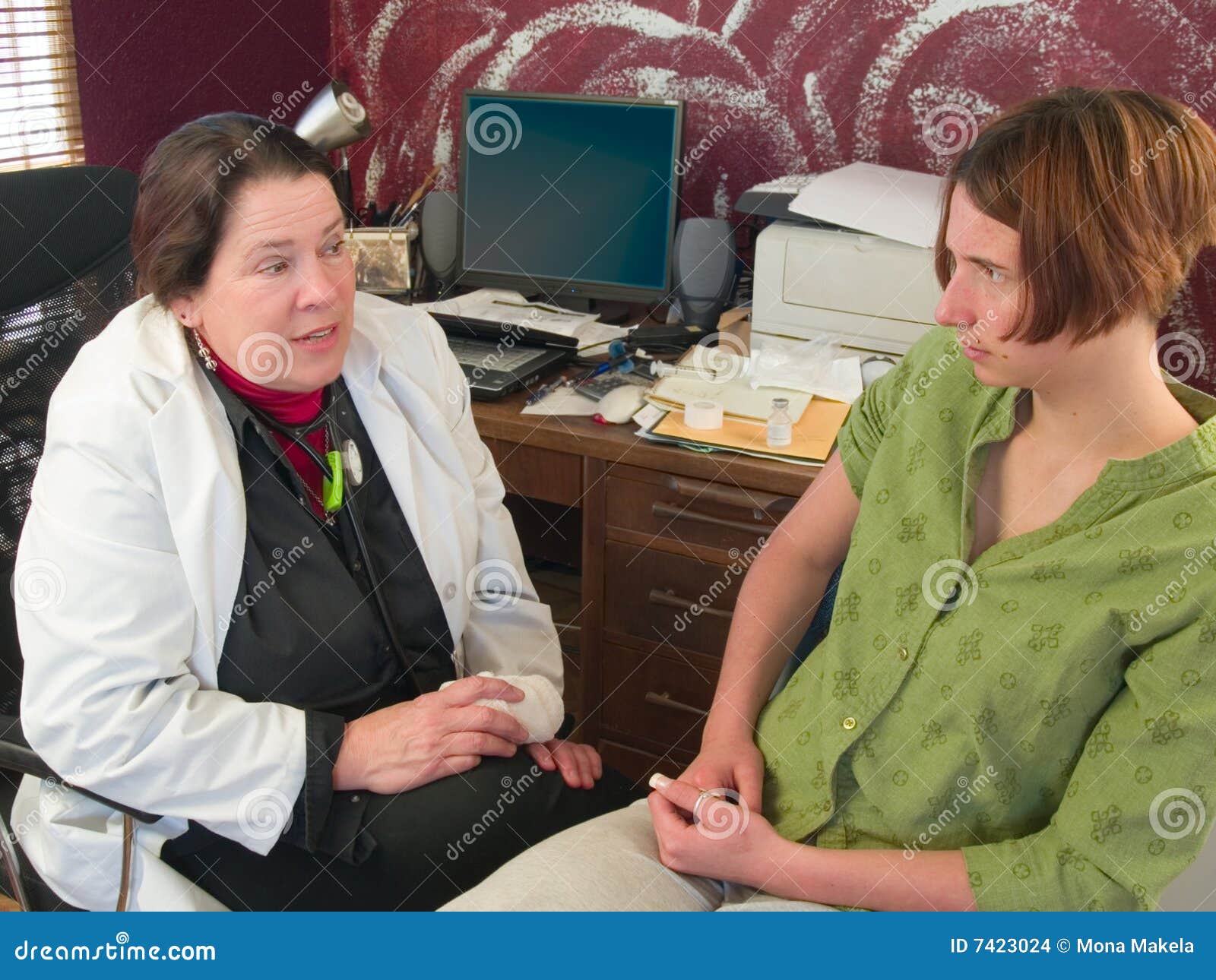Female Doctor Talking To Concerned Patient Stock Photo - Image of ...