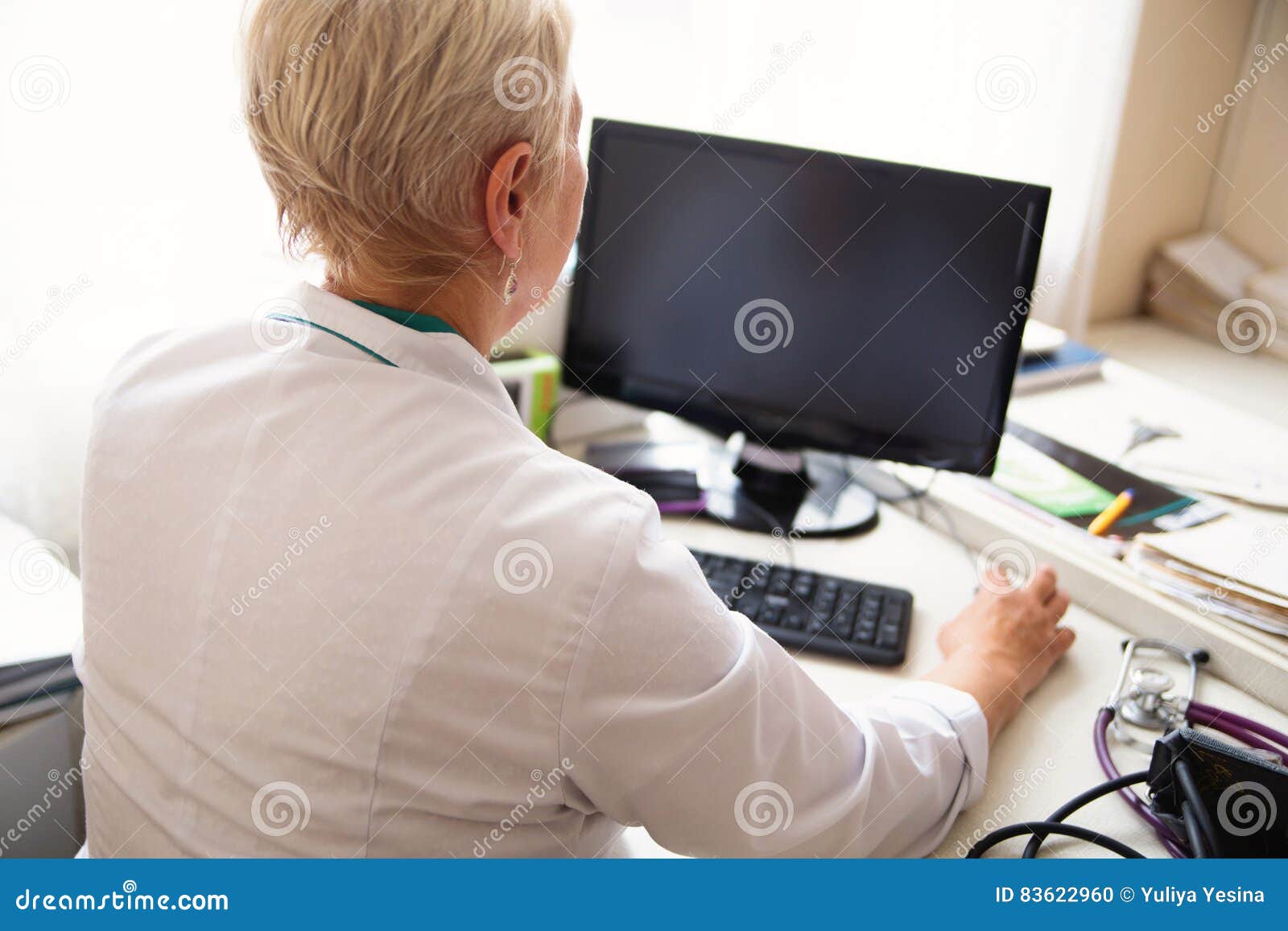 Female Doctor Using Desktop PC in Clinic Stock Photo - Image of device ...