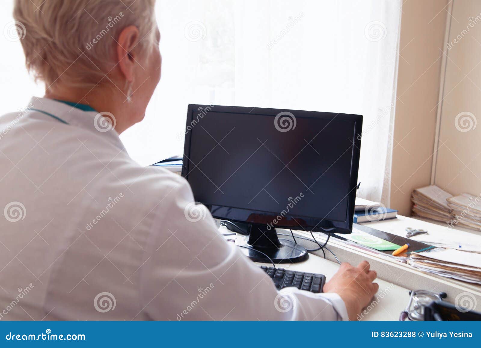 Female Doctor Using Desktop PC in Clinic Stock Photo - Image of ...
