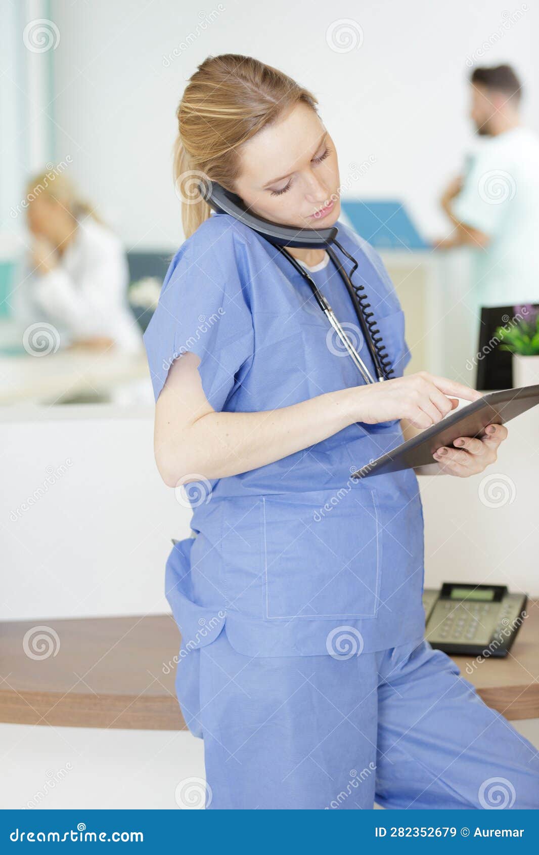 Female Doctor Using Tablet while Talking on Telephone Stock Image ...