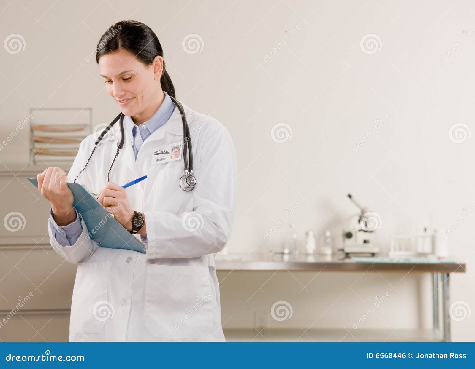 Female Doctor Writing on Medical Chart Stock Photo - Image of doctor ...