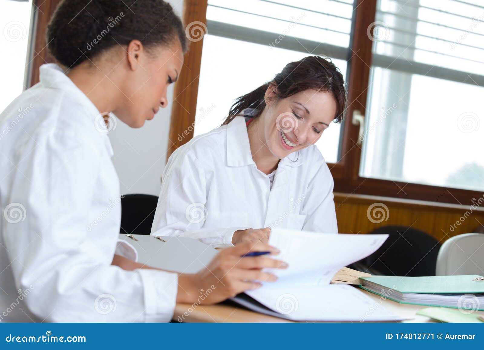 Female doctors at library stock image. Image of coworker - 174012771